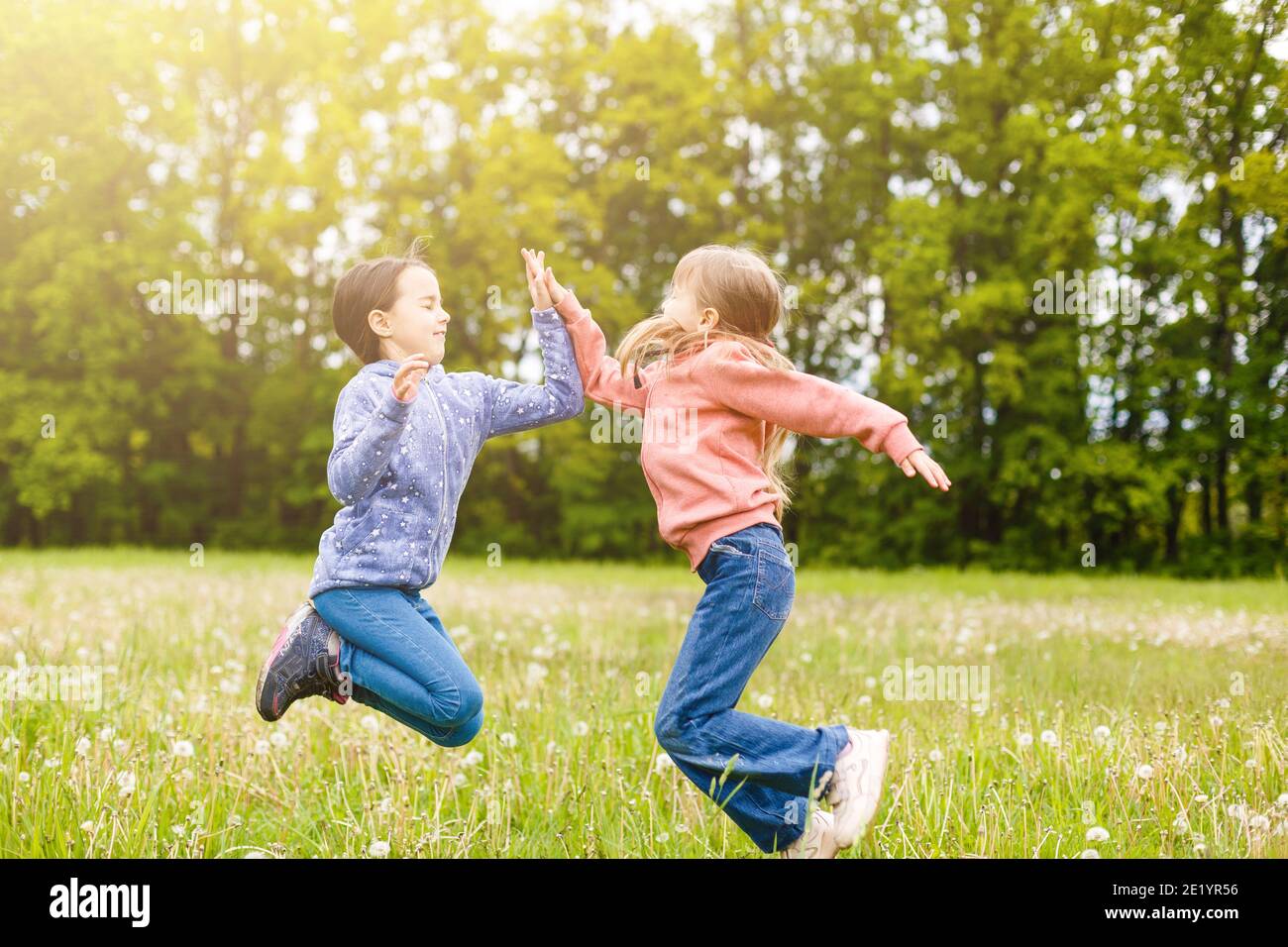 Two sisters hug one another outdoors, happy family Stock Photo - Alamy