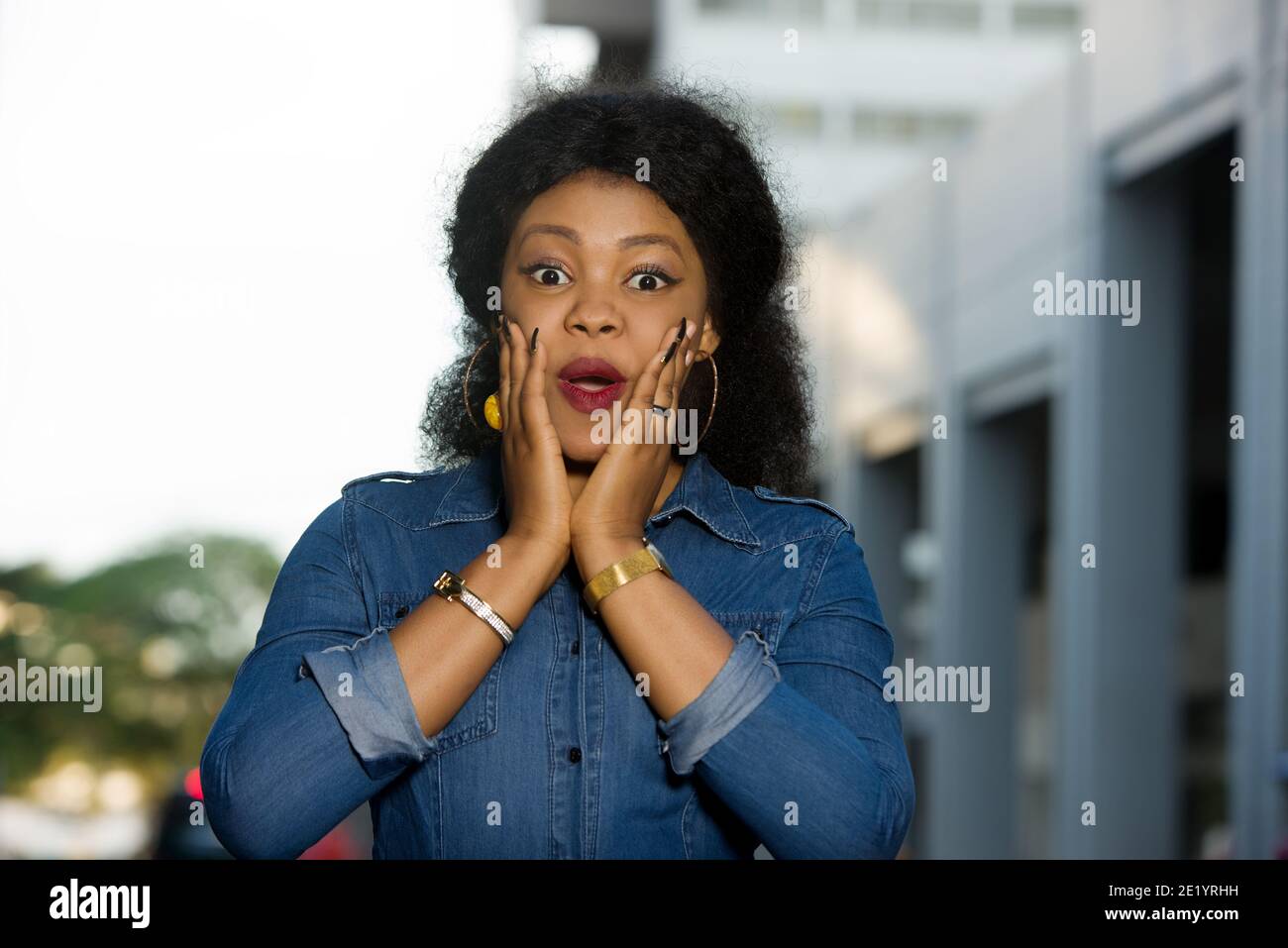 Young woman surprised in the street because of some news. She walks in ...