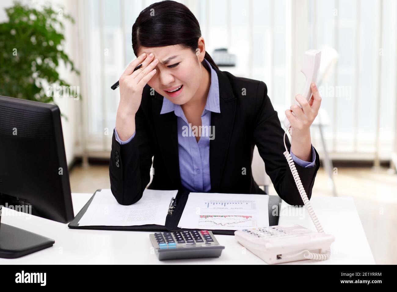 Businesswoman using a cell phone reading portfolio high quality photo ...