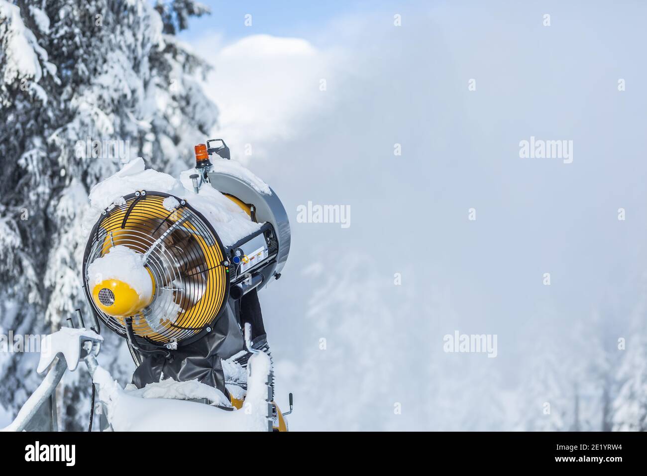 Snow cannon gun or machine sprays water and snowes a ski or cross ...