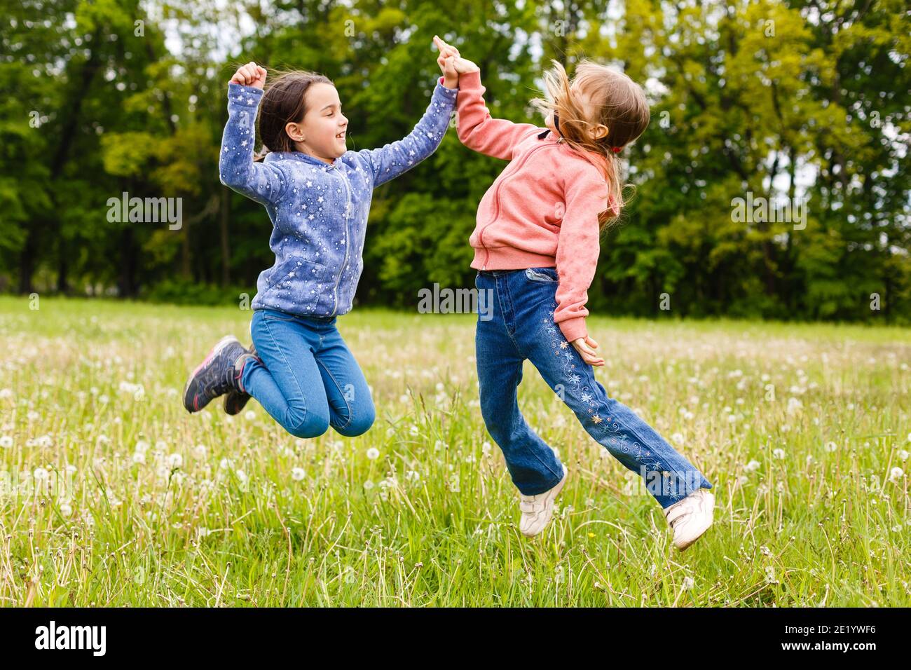 Two sisters hug one another outdoors, happy family Stock Photo - Alamy