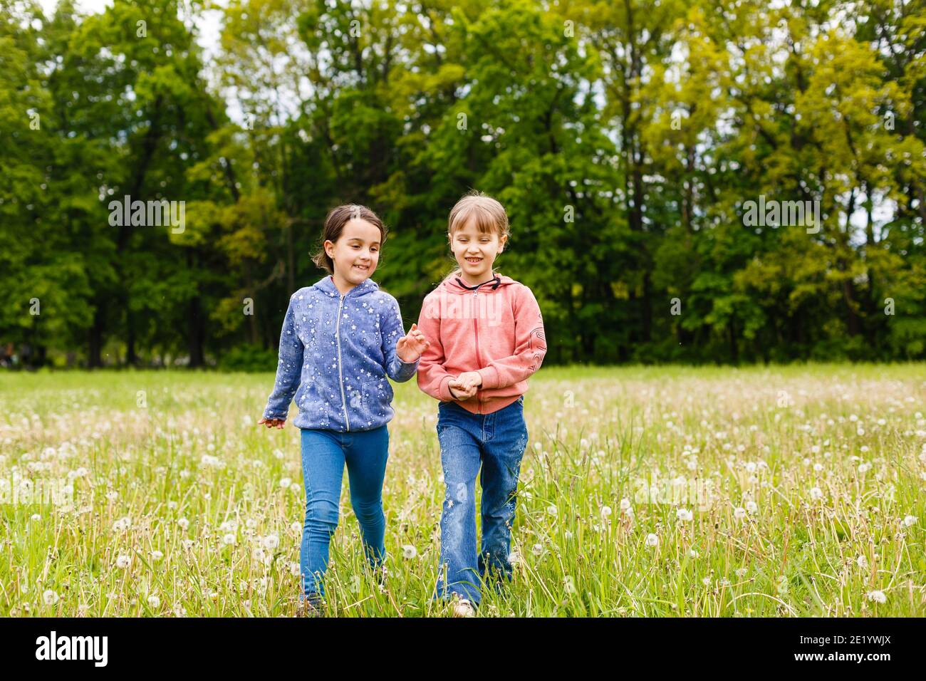 Two sisters hug one another outdoors, happy family Stock Photo - Alamy