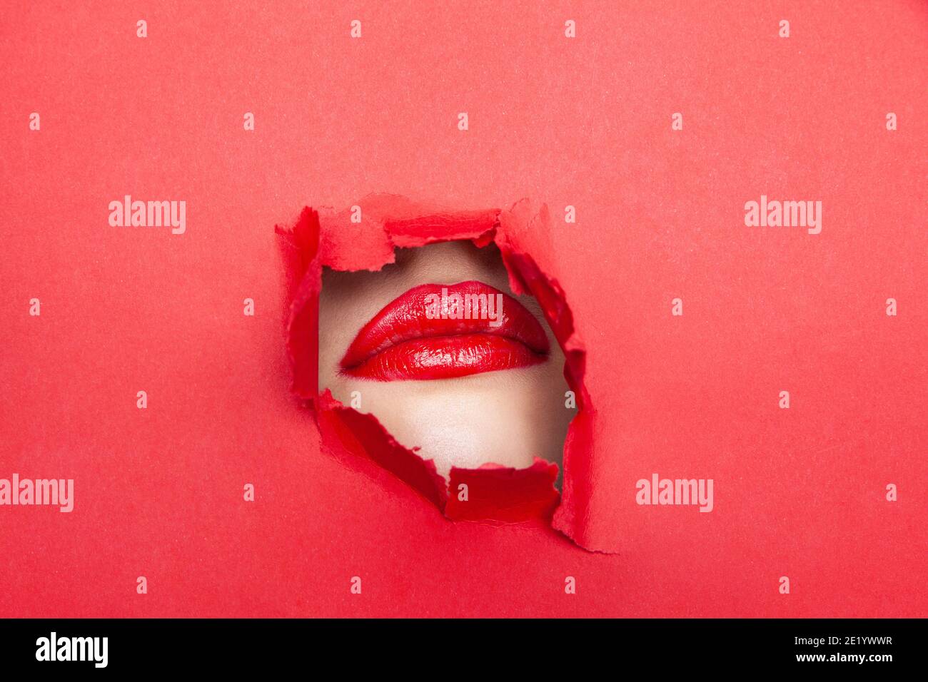 Woman with red lips through torn paper Stock Photo - Alamy