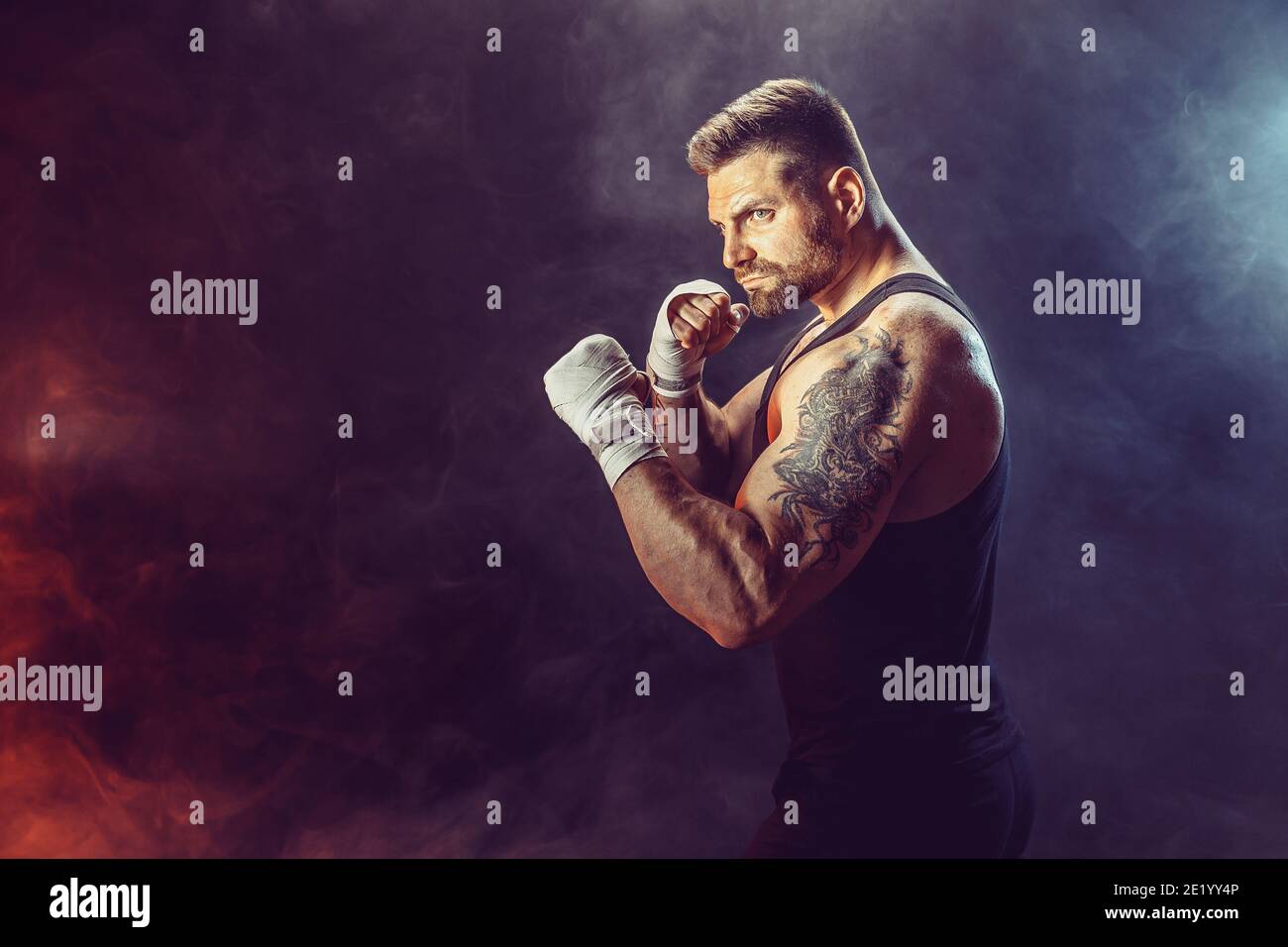 Sportsman boxer fighting on black background with shadow. Copy Space ...