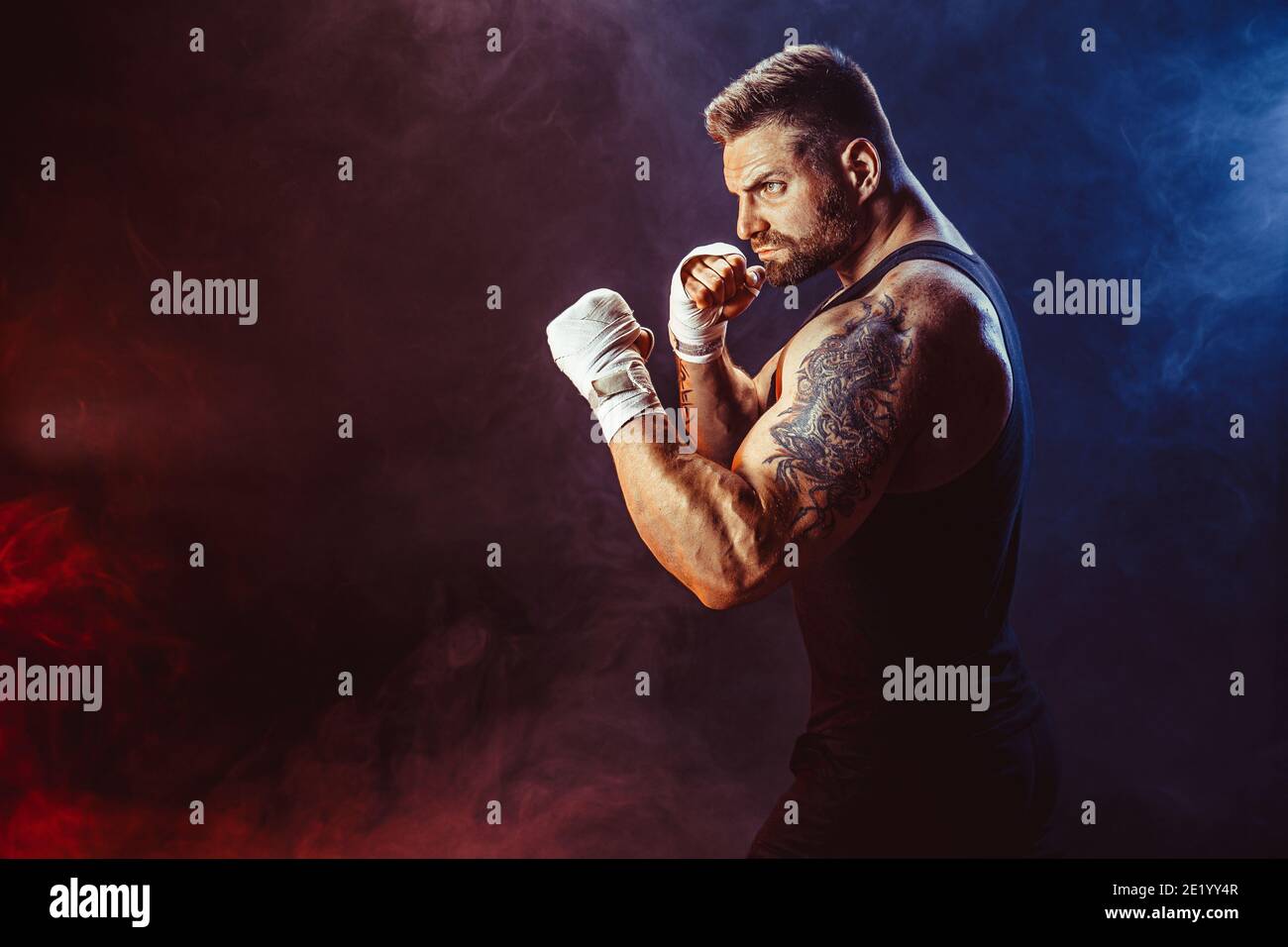 Sportsman boxer fighting on black background with shadow. Copy Space ...