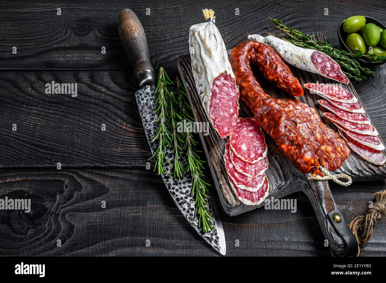 Spanish tapas sliced sausages salami, fuet and chorizo on a wooden ...