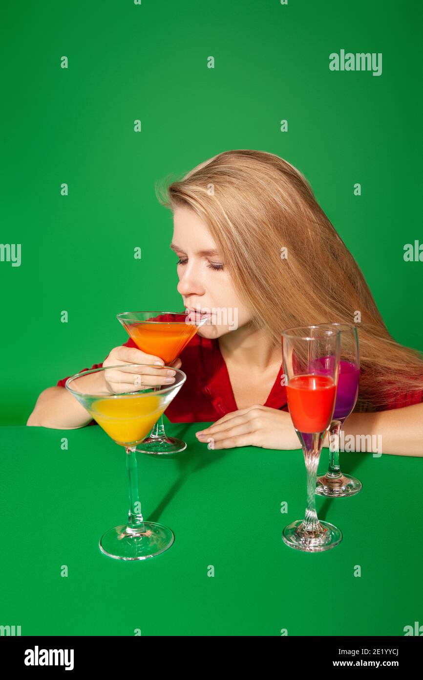 Stylish female model stretching on yellow background Stock Photo - Alamy