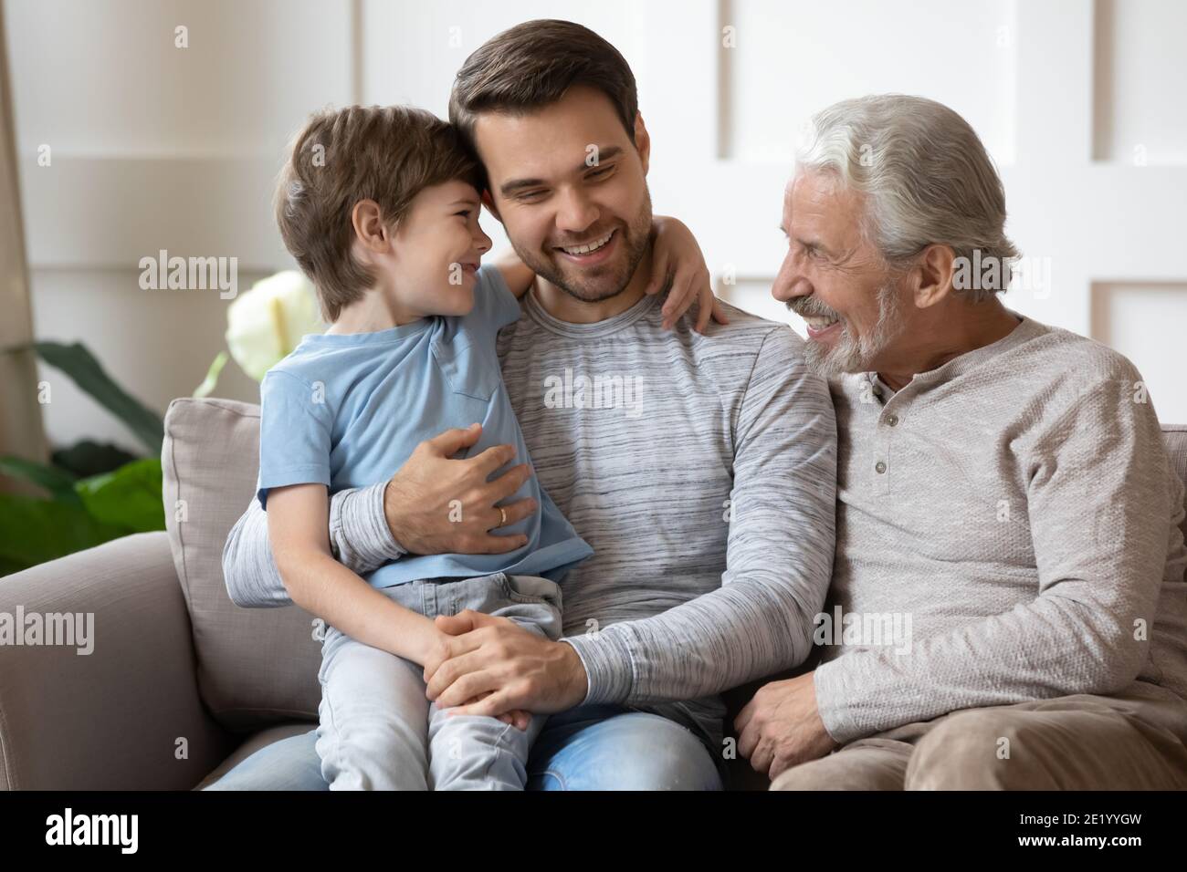 Smiling three generations of men relax at home Stock Photo - Alamy