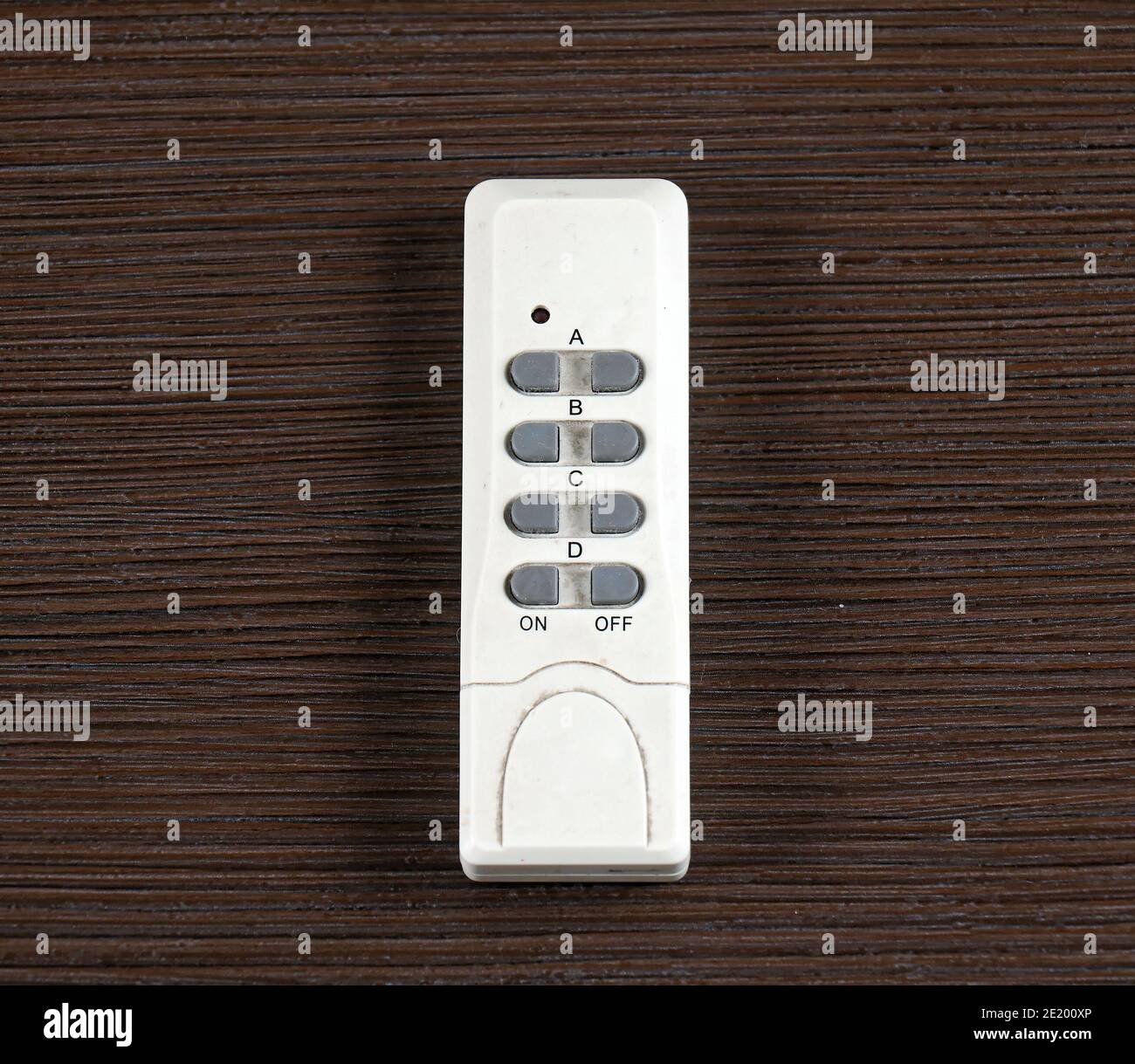 On - Off remote control with several control buttons on wooden ...