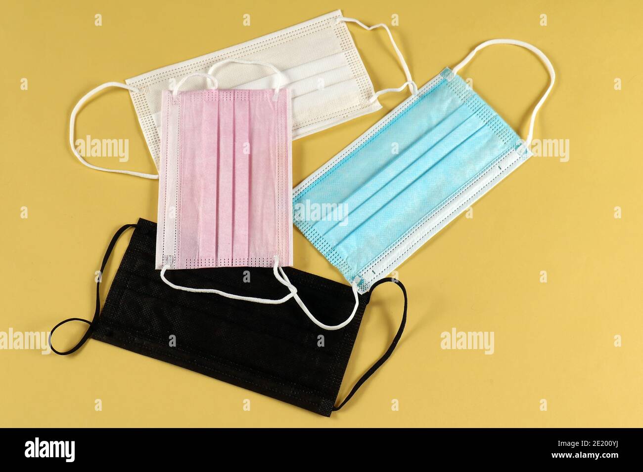 Colorful disposable face masks pile for protection against respiratory ...