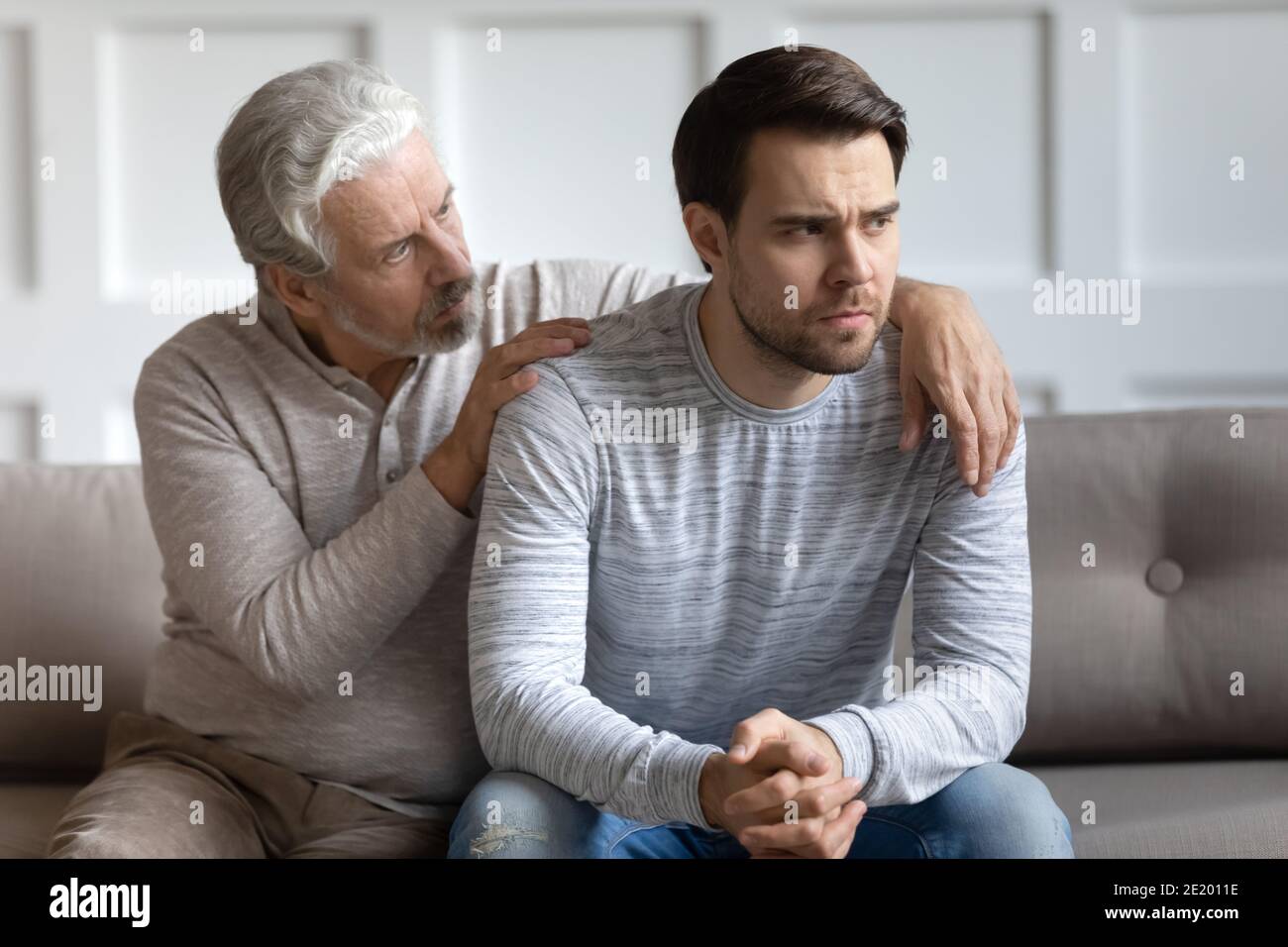 Caring old father comfort support unhappy adult son Stock Photo - Alamy