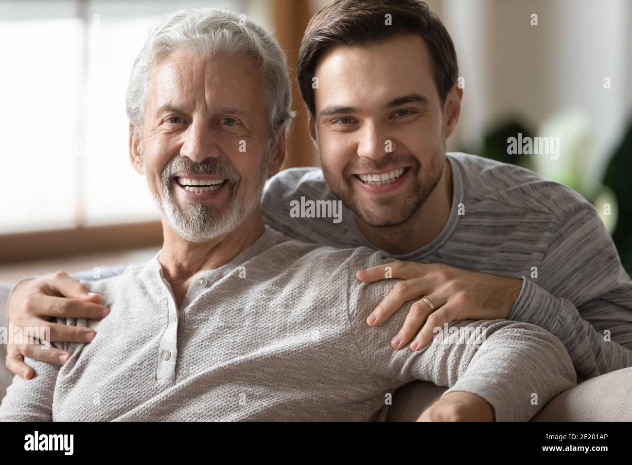 Portrait of smiling elderly father with adult son Stock Photo - Alamy