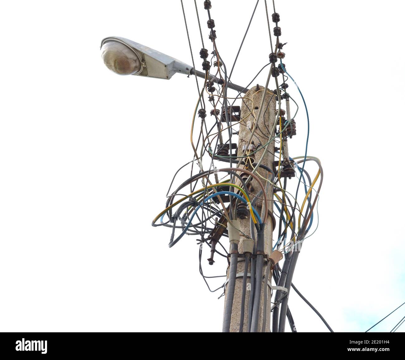 Many electric wires on concrete street pole with internet or cell phone ...