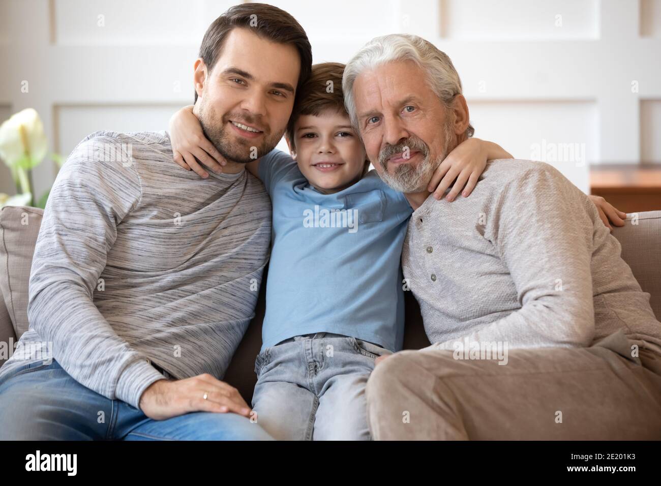 Portrait of happy three generations of men at home Stock Photo - Alamy