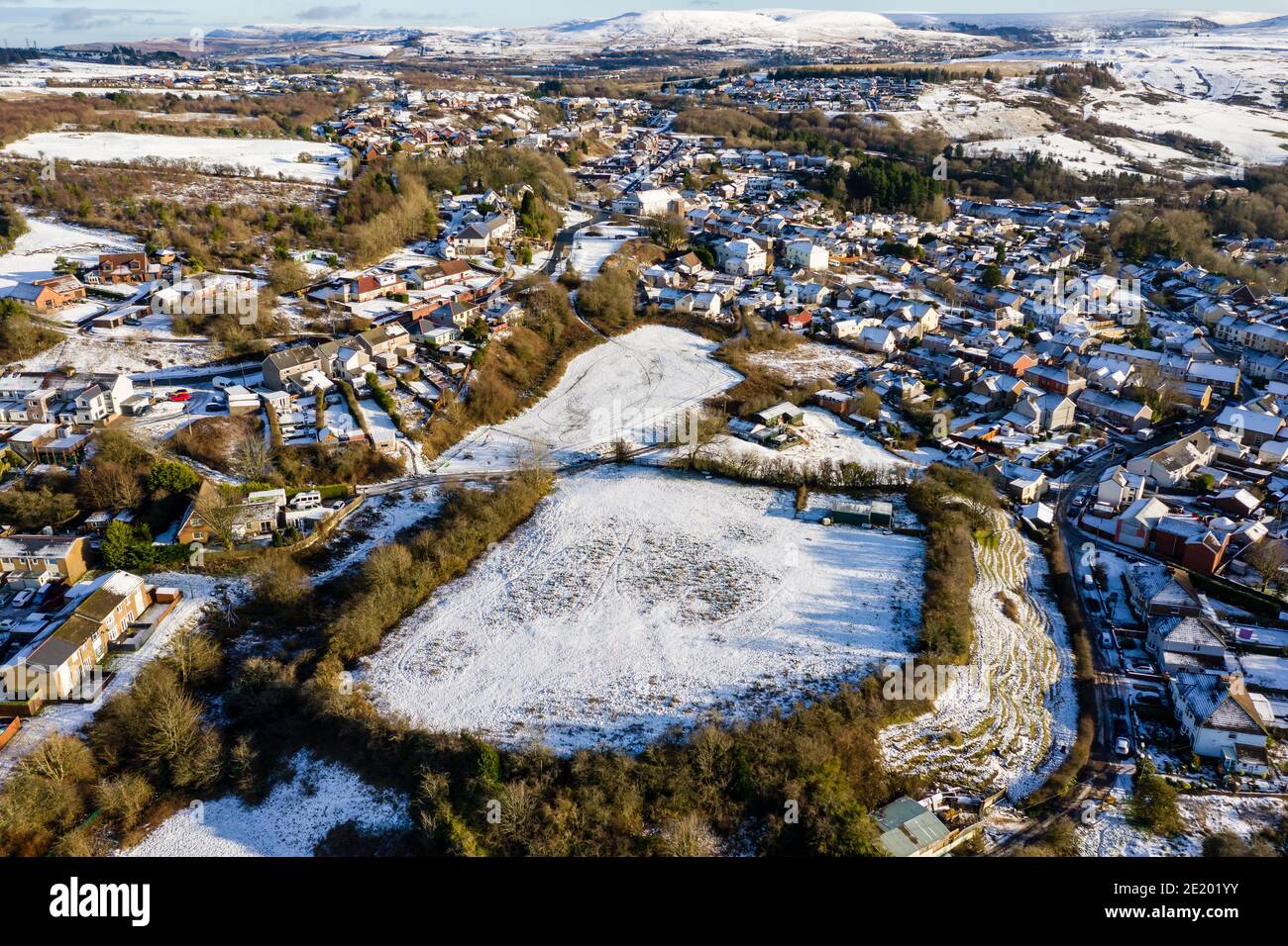Aerial view of snow covered houses and streets in a small town (Ebbw ...