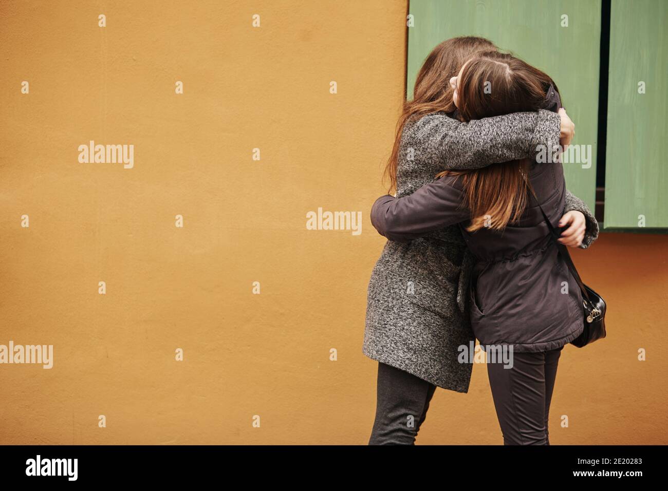 Happy meeting of two friends hugging in the street Stock Photo - Alamy