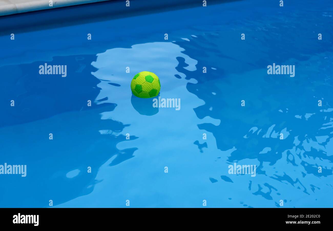 Surface of blue swimming pool with ball, background of water in ...