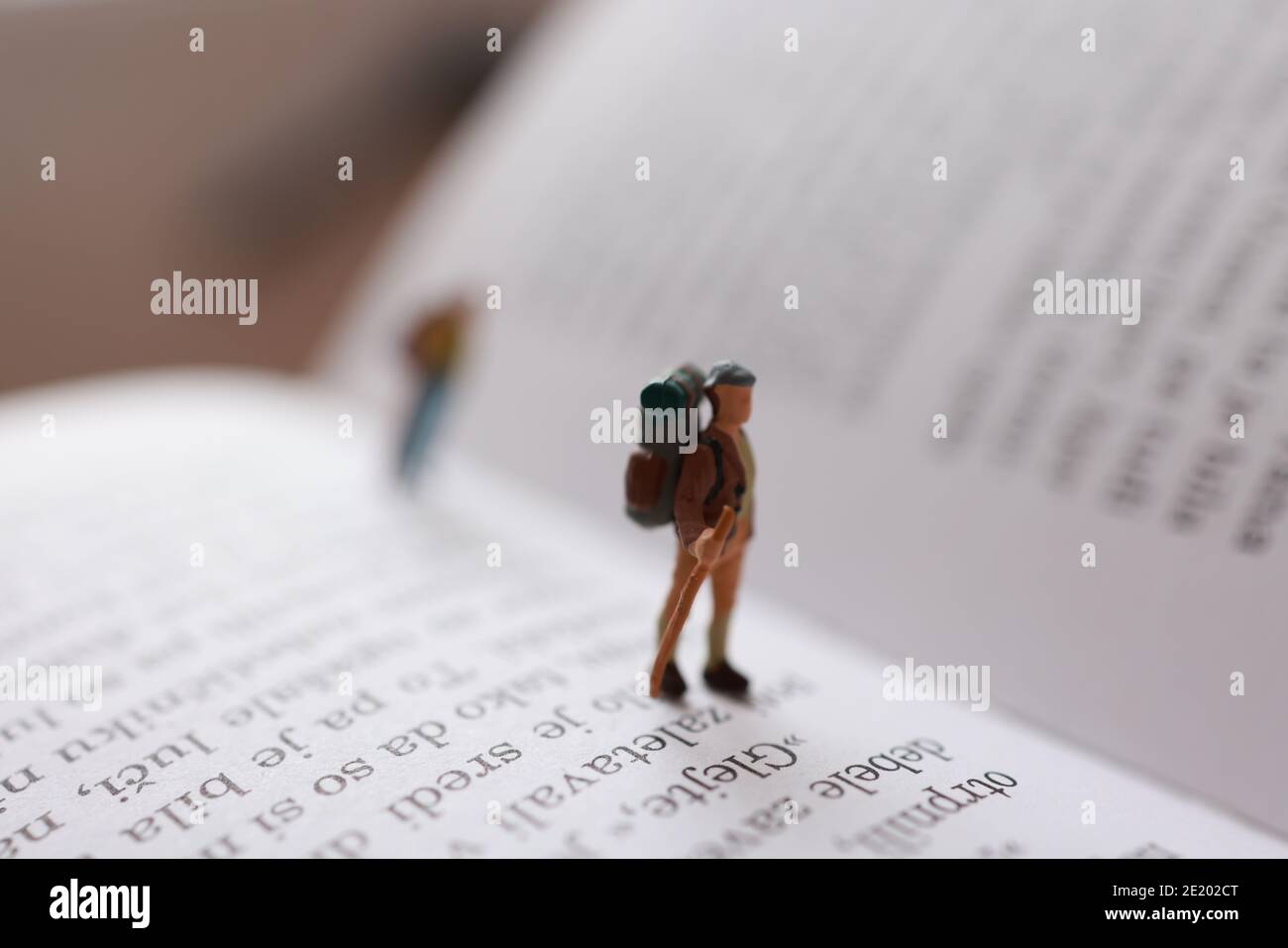 Miniature People Walking On A Book Paper Stock Photo - Alamy