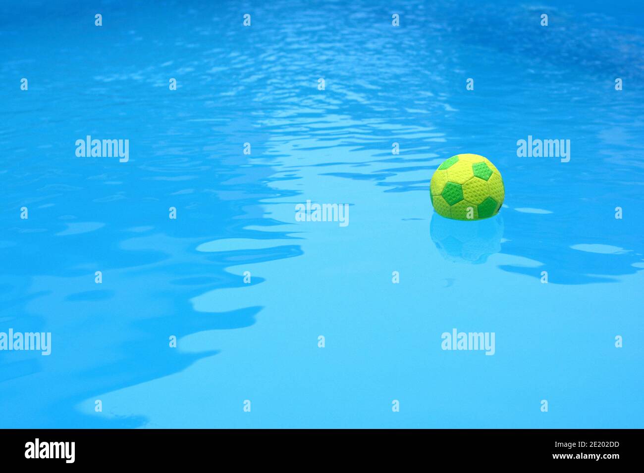 Surface of blue swimming pool with ball, background of water in ...