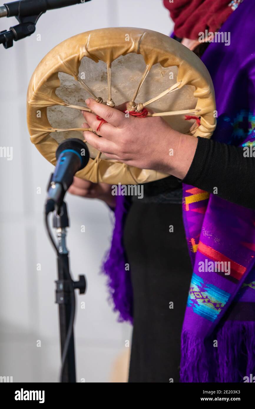 Sound demonstration during a native drum workshop. Woman in colored ...