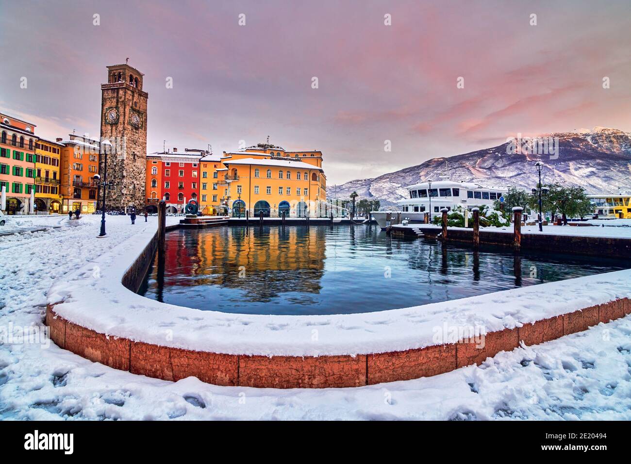 Beautiful view of Riva del Garda on a winter day with lots of snow ...