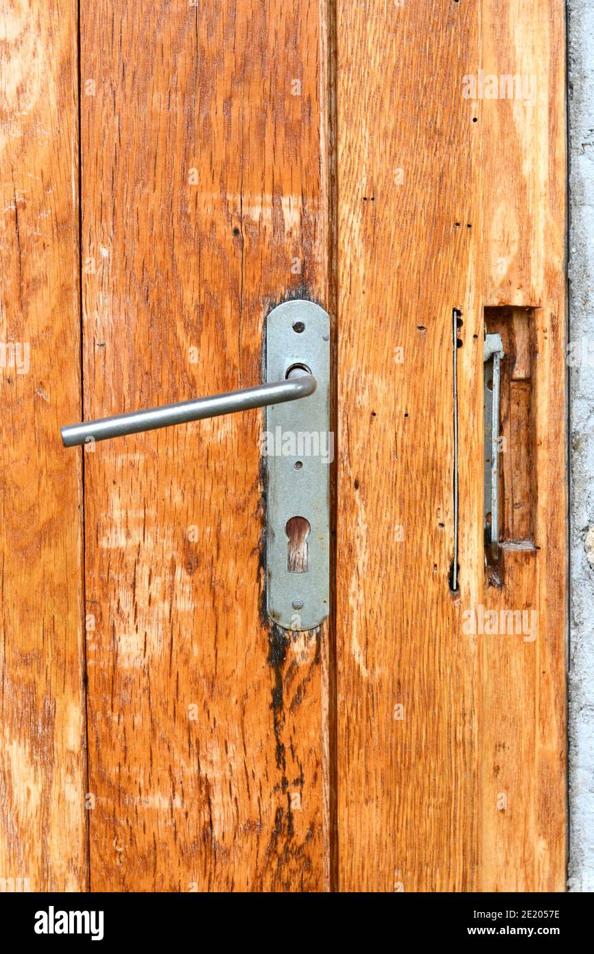 An old retro handle on a wooden door. Antique door handle Stock Photo ...
