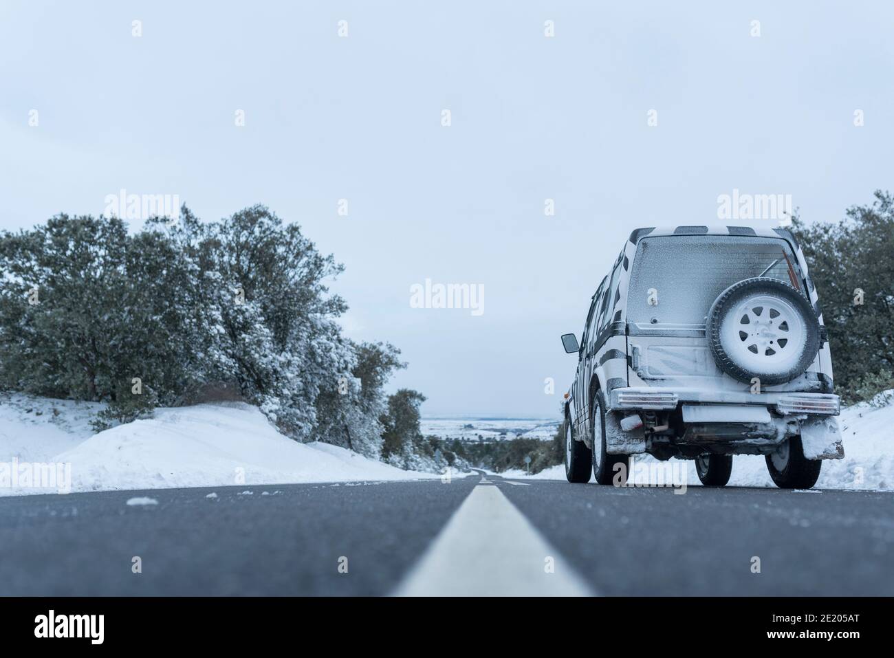 off-road car with snow on symmetrical road Stock Photo - Alamy