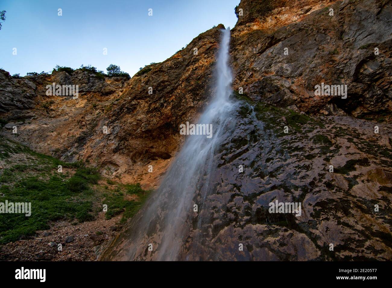 The picturesque waterfall Rinka falls from a steep ledge. Slovenia ...