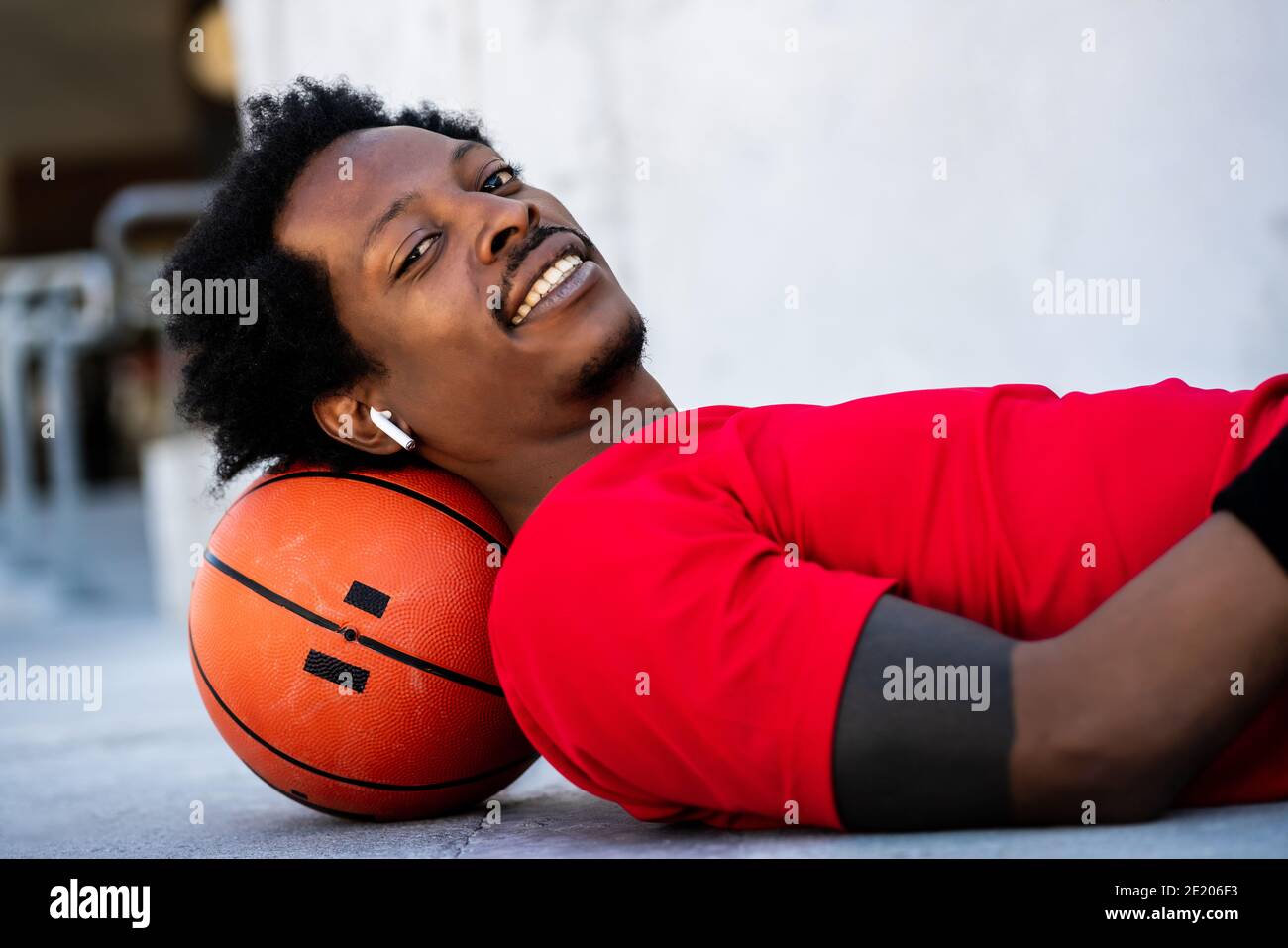 Afro athlete man laying on floor after training Stock Photo - Alamy