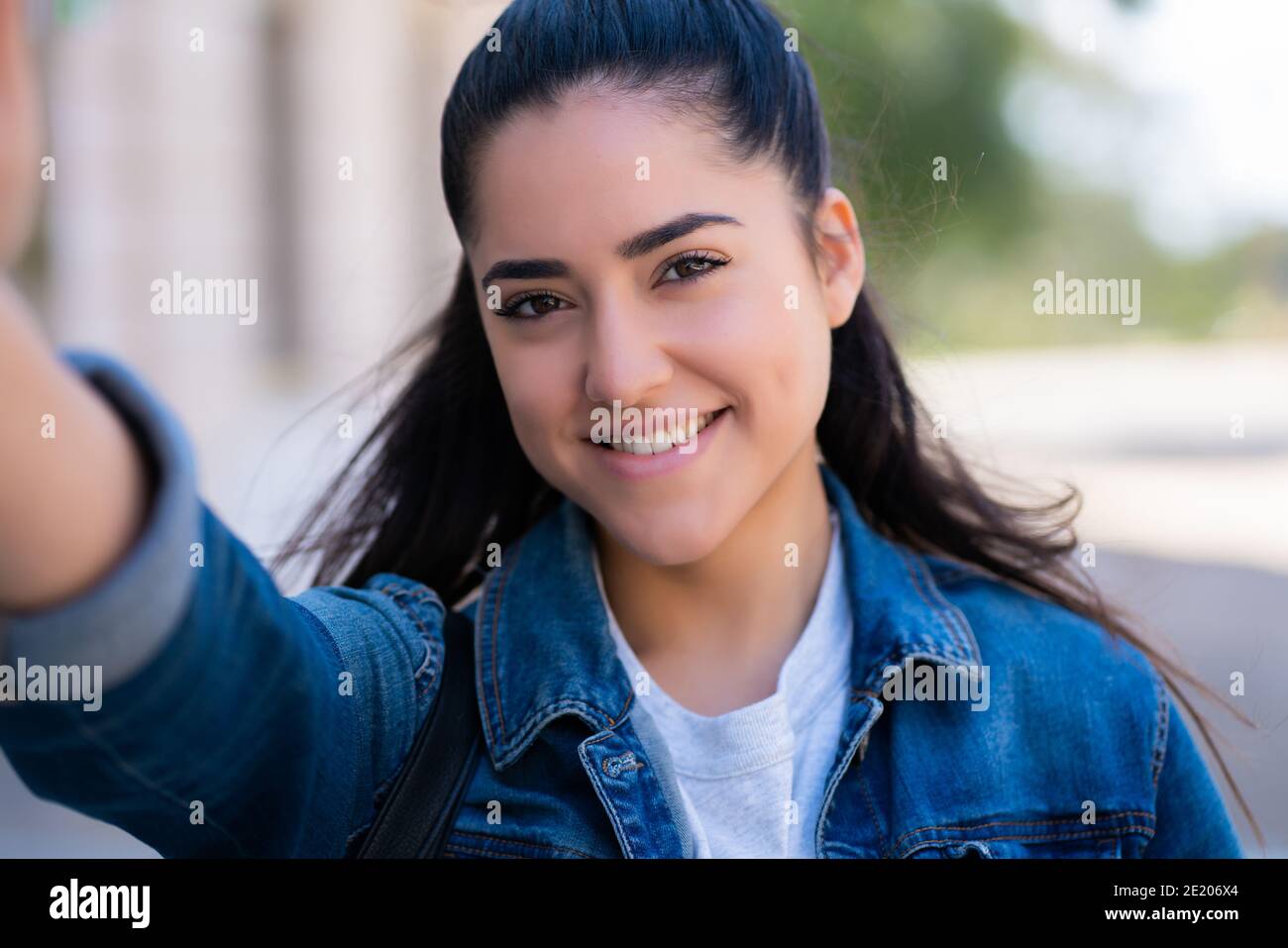 Young woman taking selfies outdoors Stock Photo - Alamy