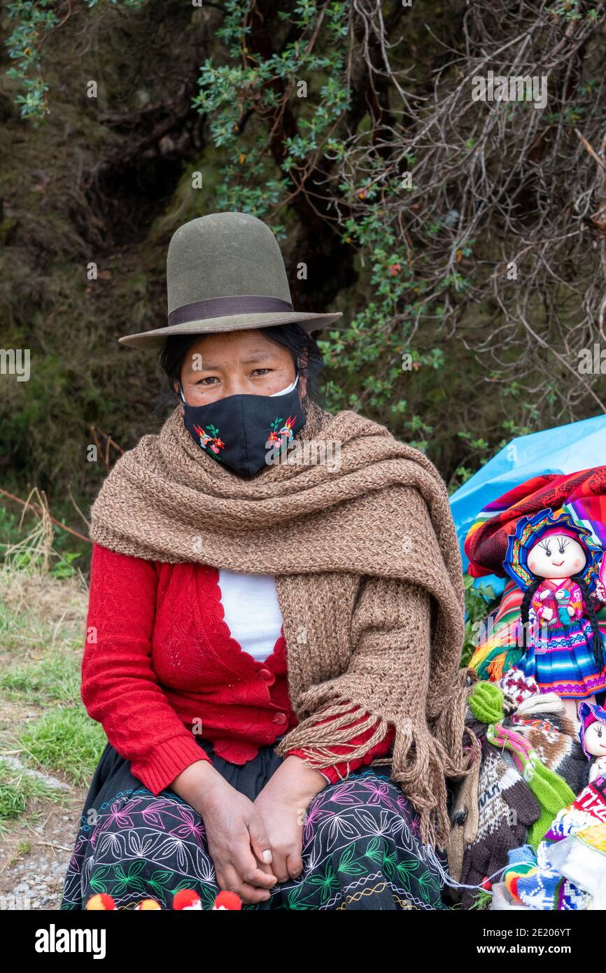 A vendor in native dress sells wares at archaeological site of ...