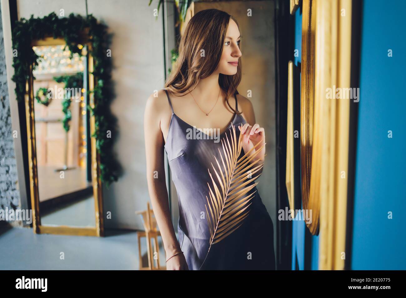 A happy pregnant woman looks lovingly at a reflection of herself and ...