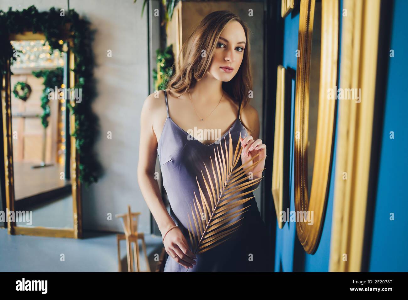 A happy pregnant woman looks lovingly at a reflection of herself and ...