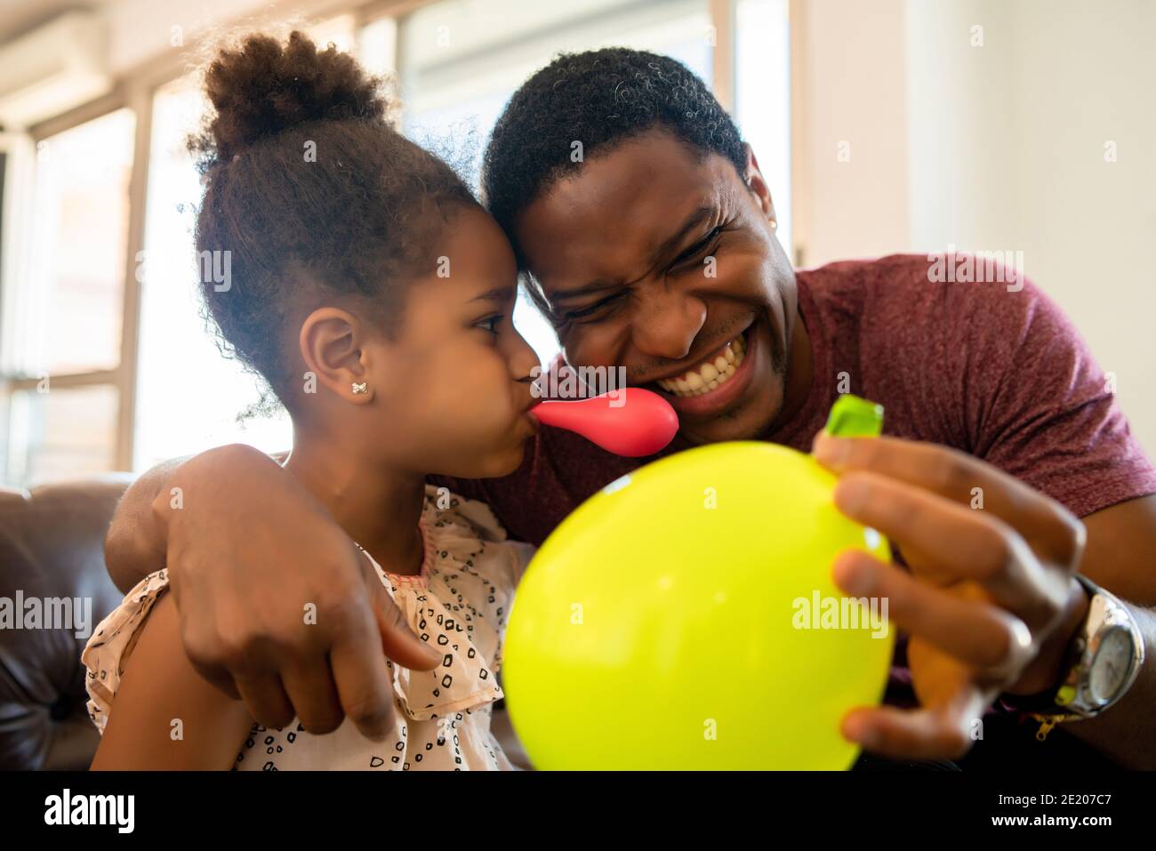 Daughter and father playing together at home Stock Photo - Alamy