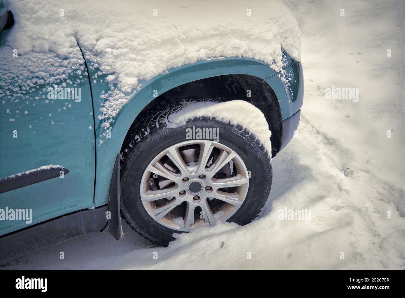 Car under a thick layer of snow. A car covered with a thick layer of ...