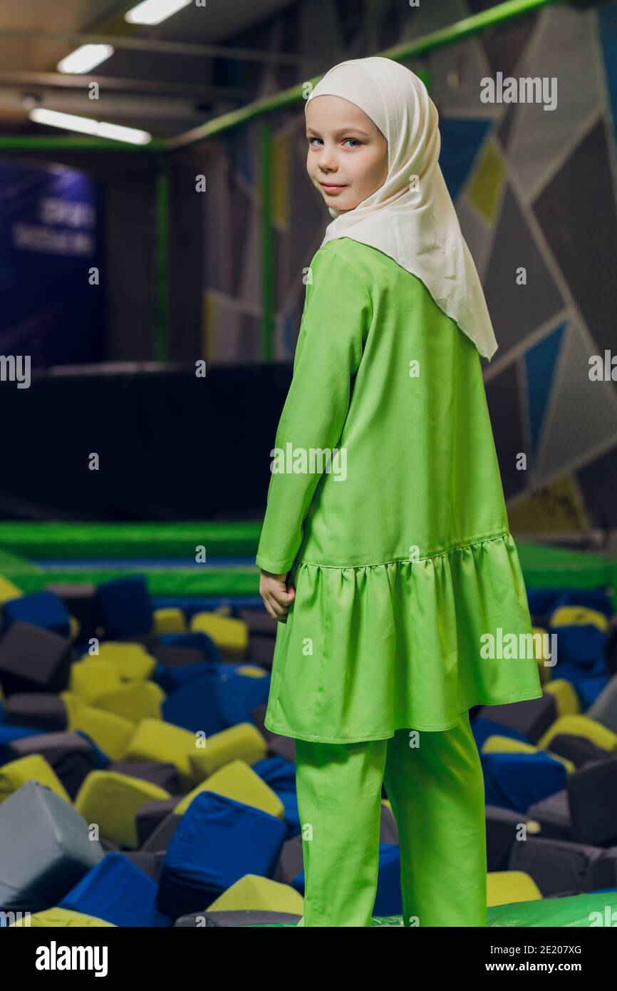 Side portrait of a little Muslim girl wearing a hijab. Concept of ...