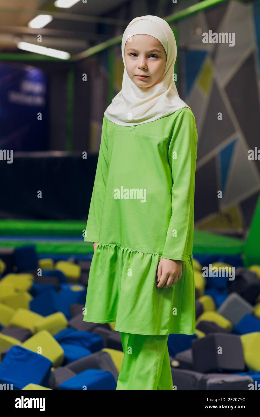 Side portrait of a little Muslim girl wearing a hijab. Concept of ...