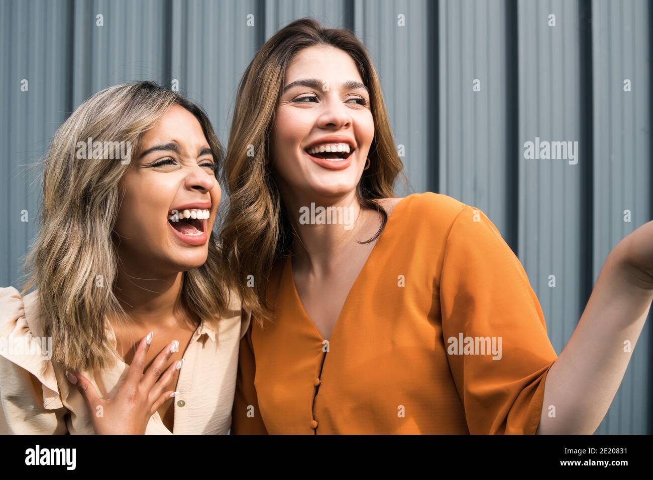 Happy young female friends pose hi-res stock photography and images - Alamy