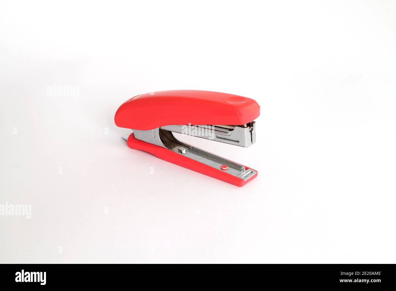 Red office stapler on an isolated white background Stock Photo - Alamy