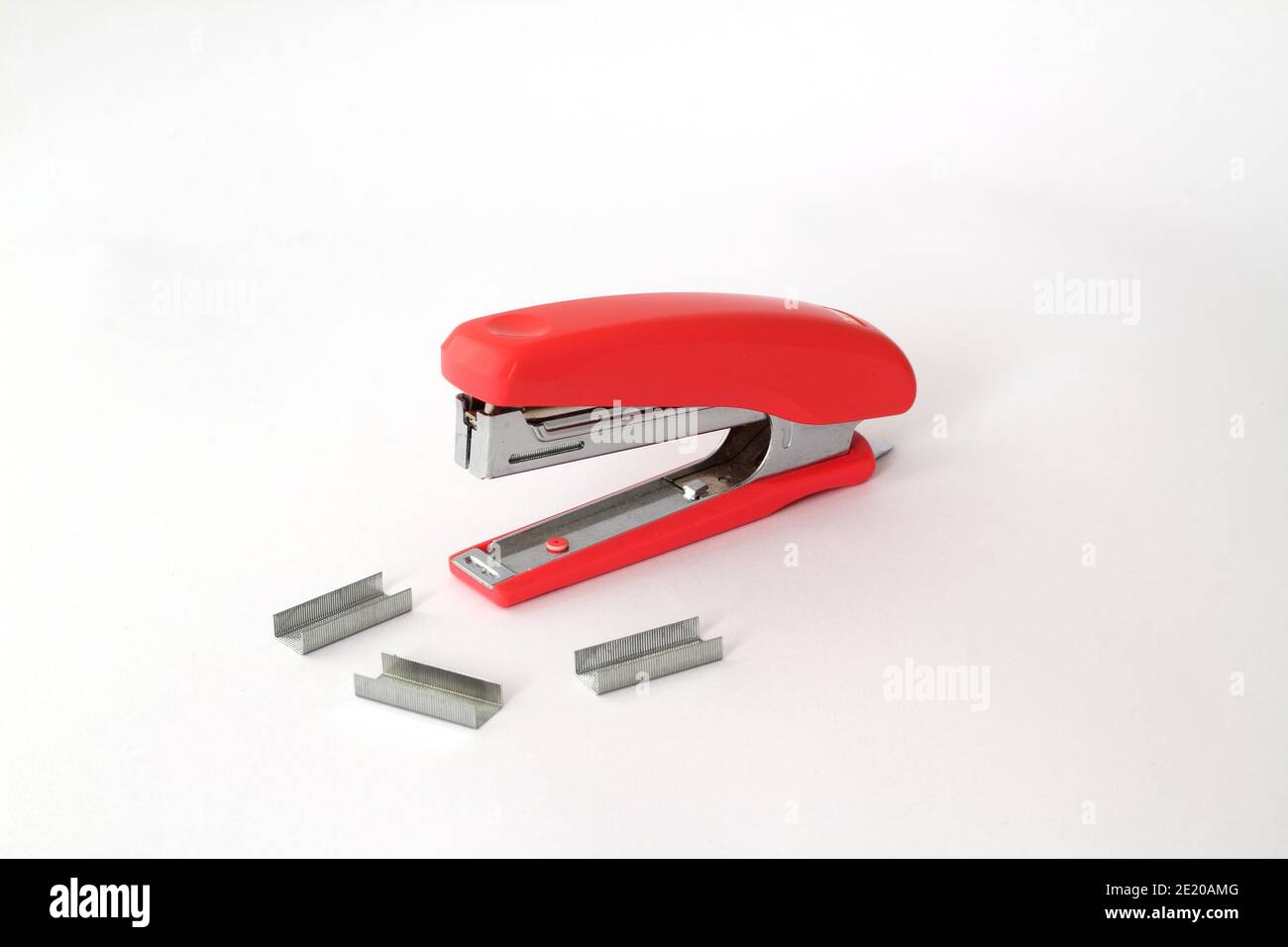 Red office stapler on an isolated white background Stock Photo - Alamy