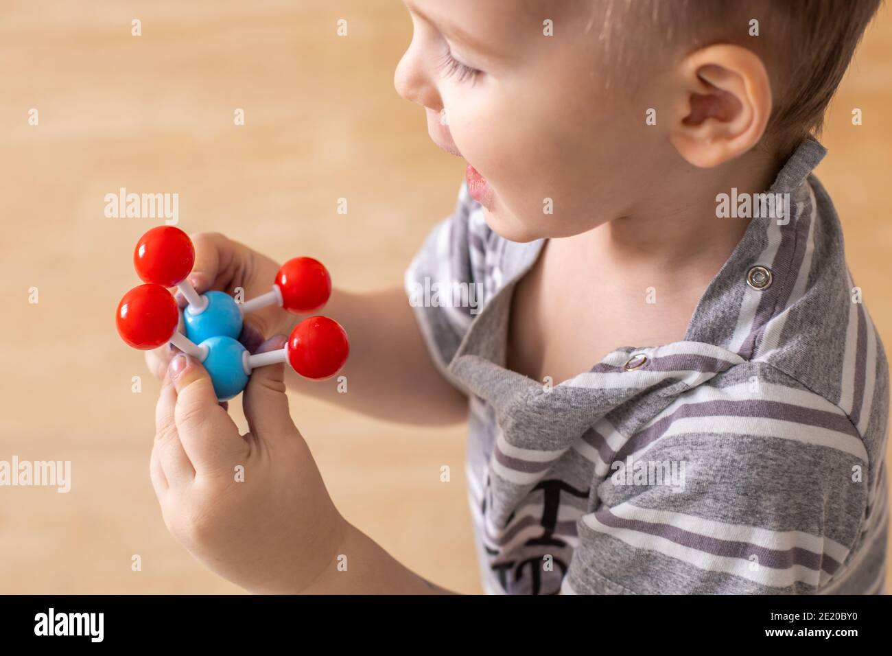 The boy collects a water molecule model from the constructor using the ...