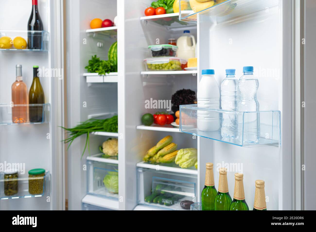 Open fridge full of fruits, vegetables and drinks Stock Photo - Alamy