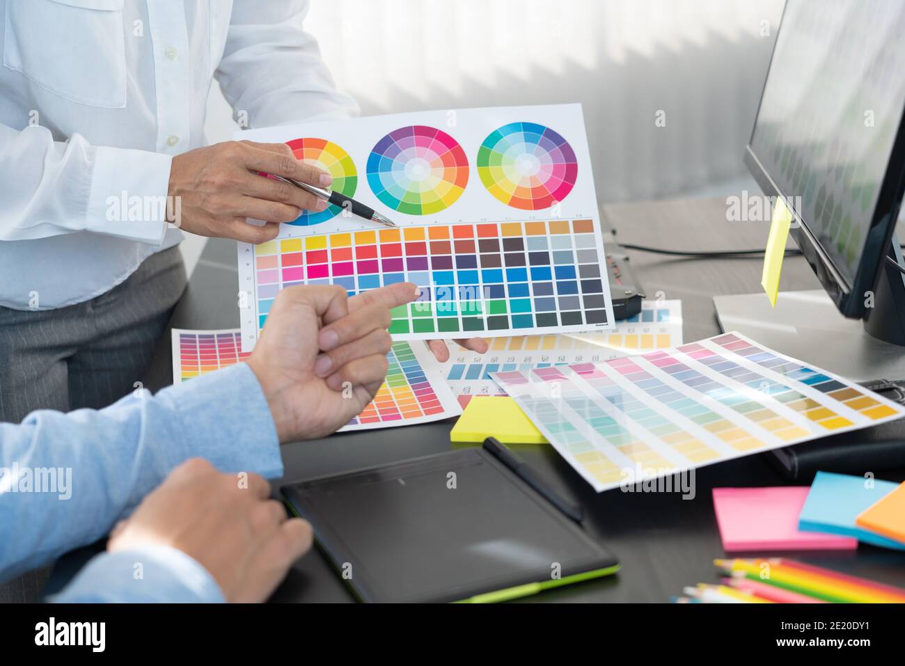 graphic designer team working on web design using color swatches ...