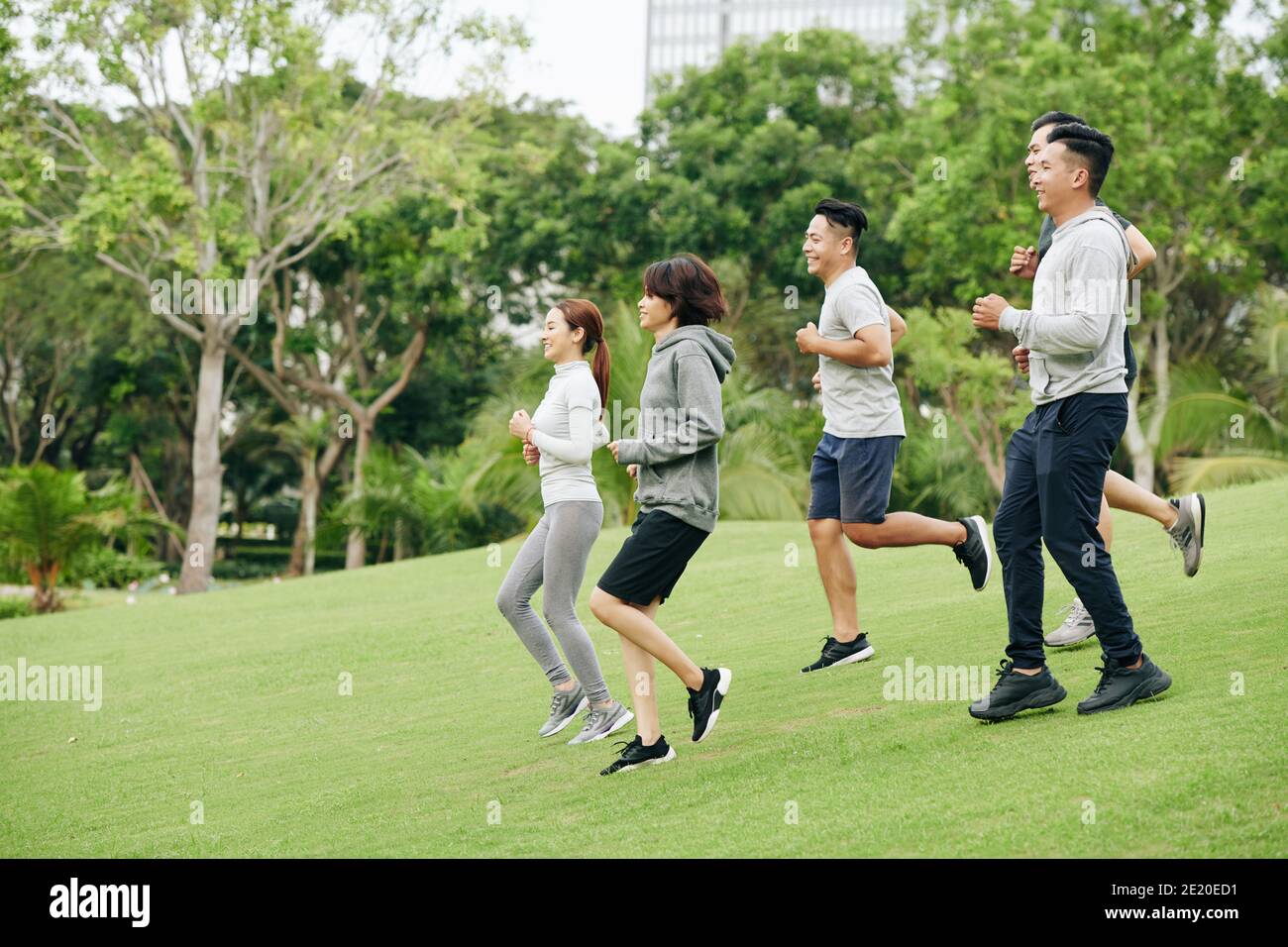 Jumping positive young people Stock Photo - Alamy
