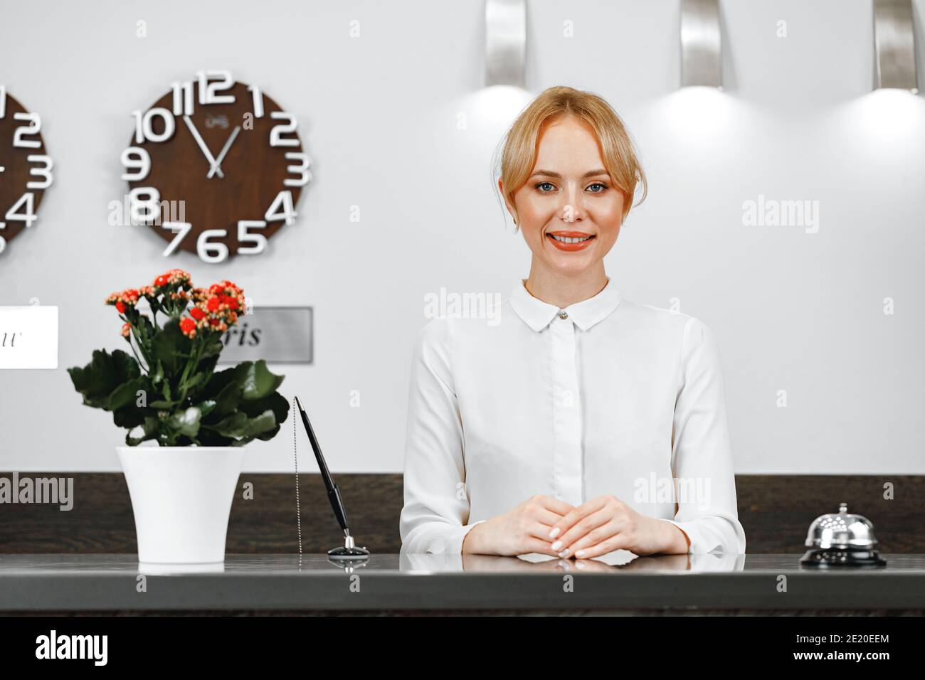 Portrait of beautiful blonde woman hotel receptionist Stock Photo - Alamy