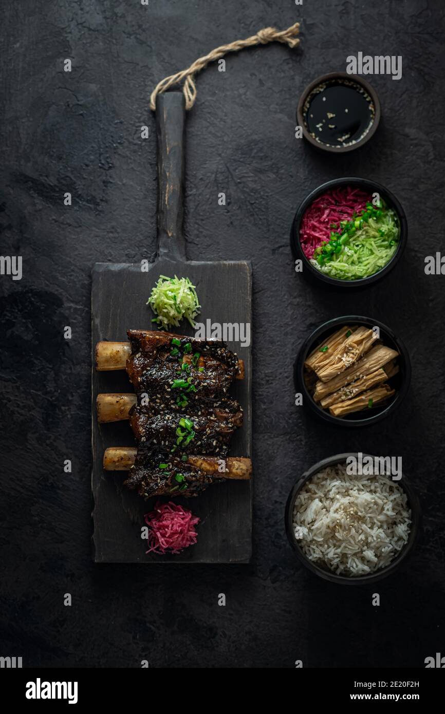 Braise beef short ribs, asian style with rice and radish, dark photo ...