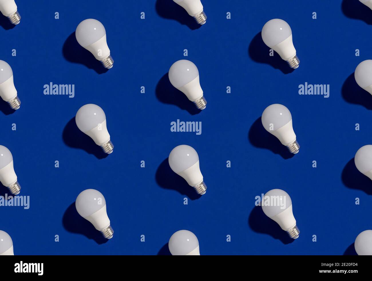 Pattern with LED energy saving light bulbs on blue background ...