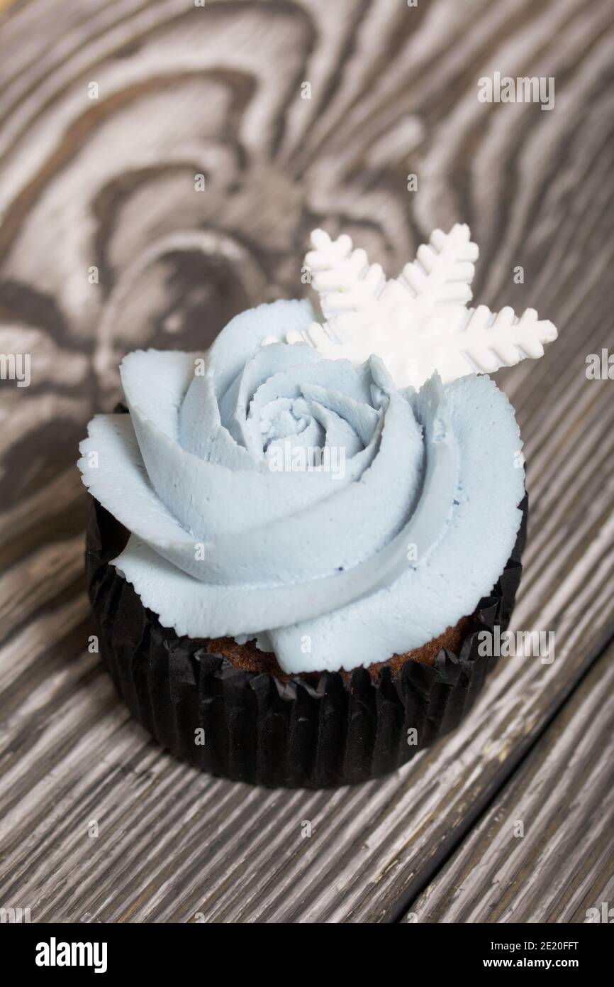 Muffin with cream cheese cream. Decorated with a marshmallow snowflake ...