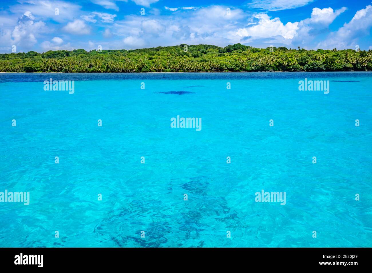 An idyllic tropical view of the shallow lagoon and the island of Yap ...