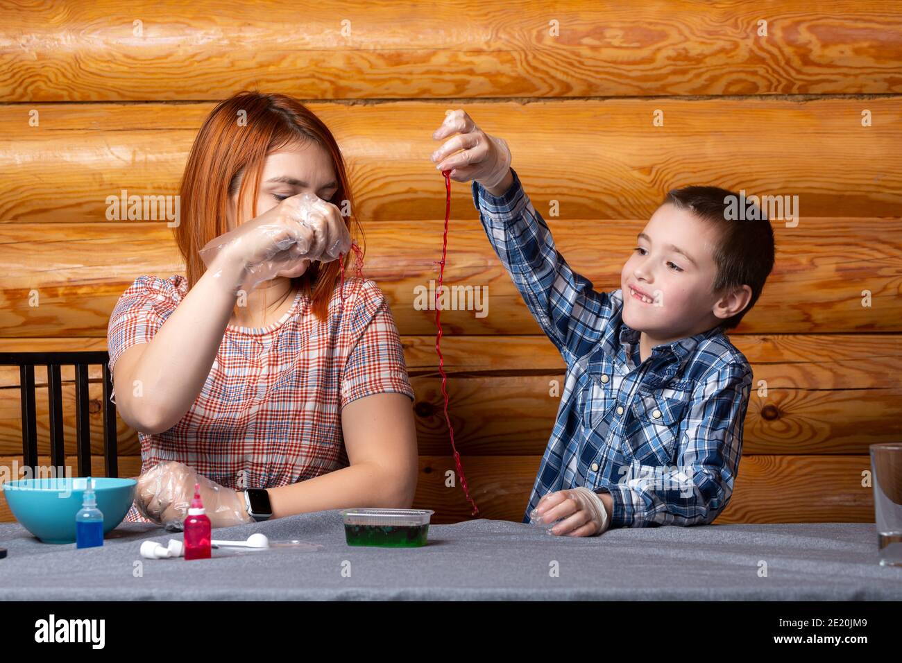 Mom and son are doing chemical experiments, making multi-colored ...